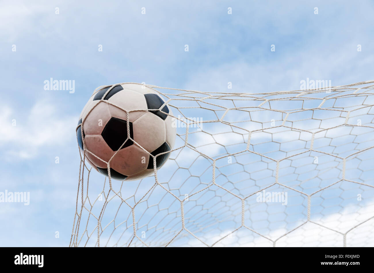 Soccer football in Goal net with Sky field. For sport concept Stock ...