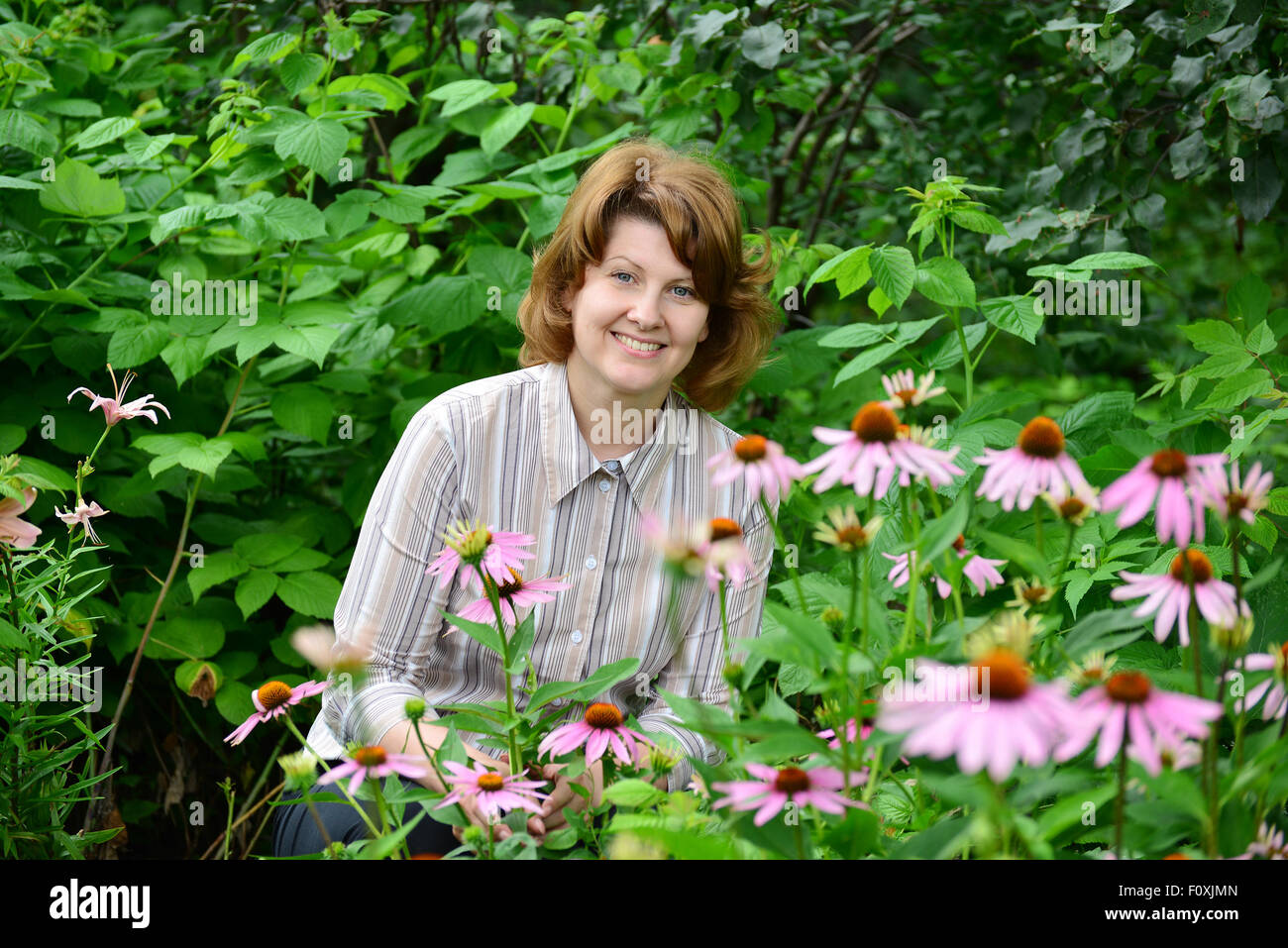 Young woman behind flower hi-res stock photography and images - Alamy