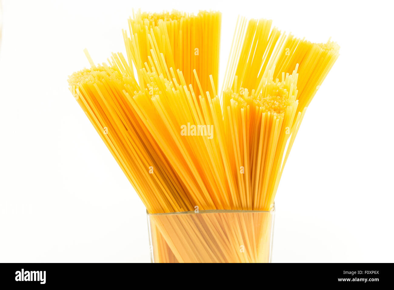 Spaghetti in a glass container isolated on white Stock Photo - Alamy
