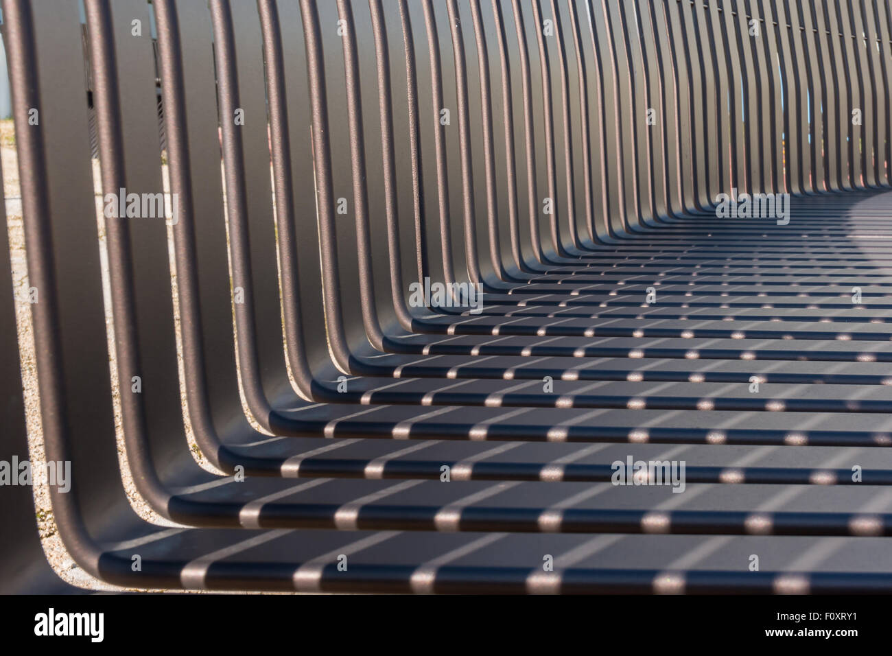 Empty black metal bench near playground Stock Photo - Alamy