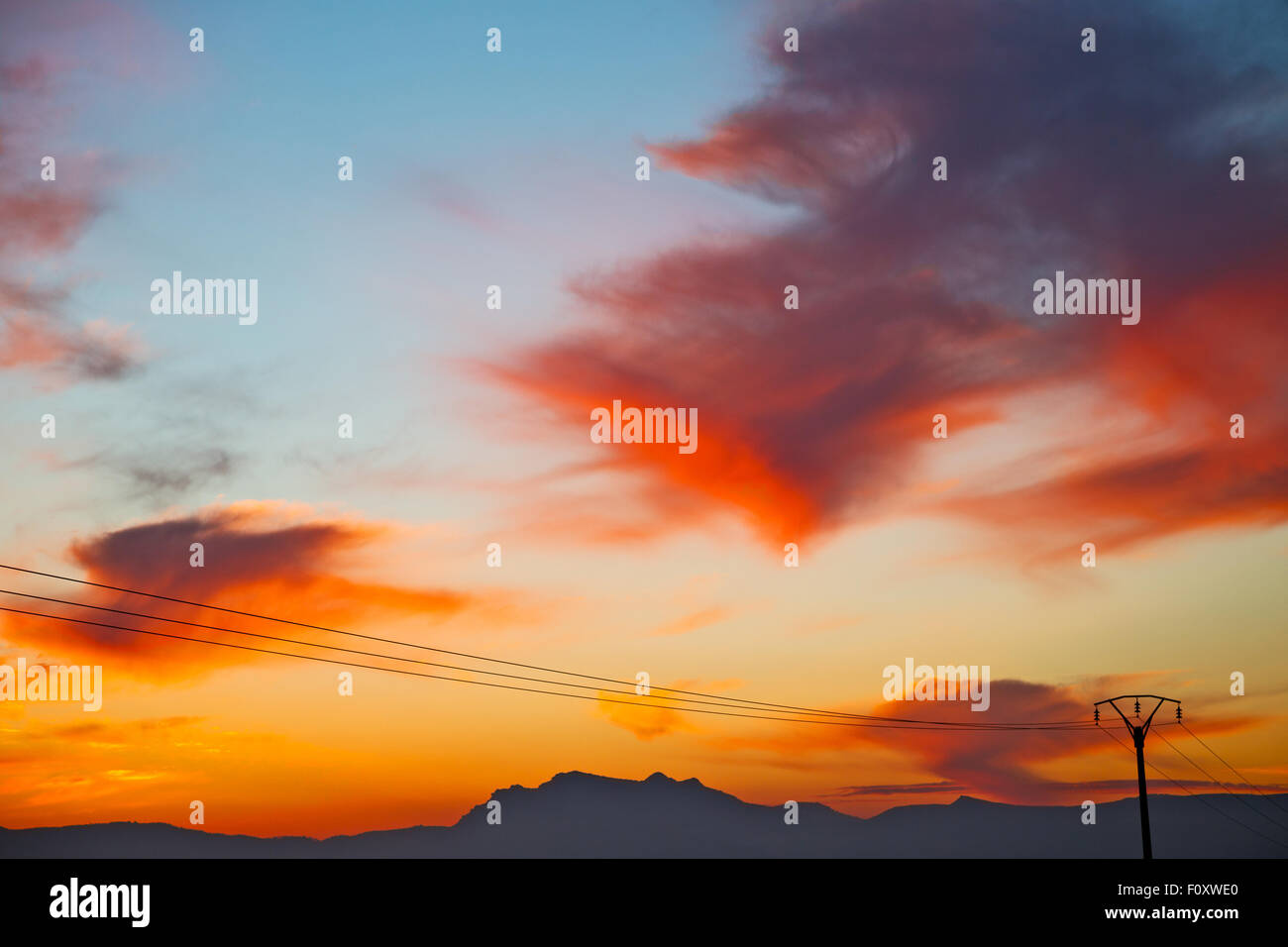 mountain in morocco africa and red sunrise current cables power pylon ...
