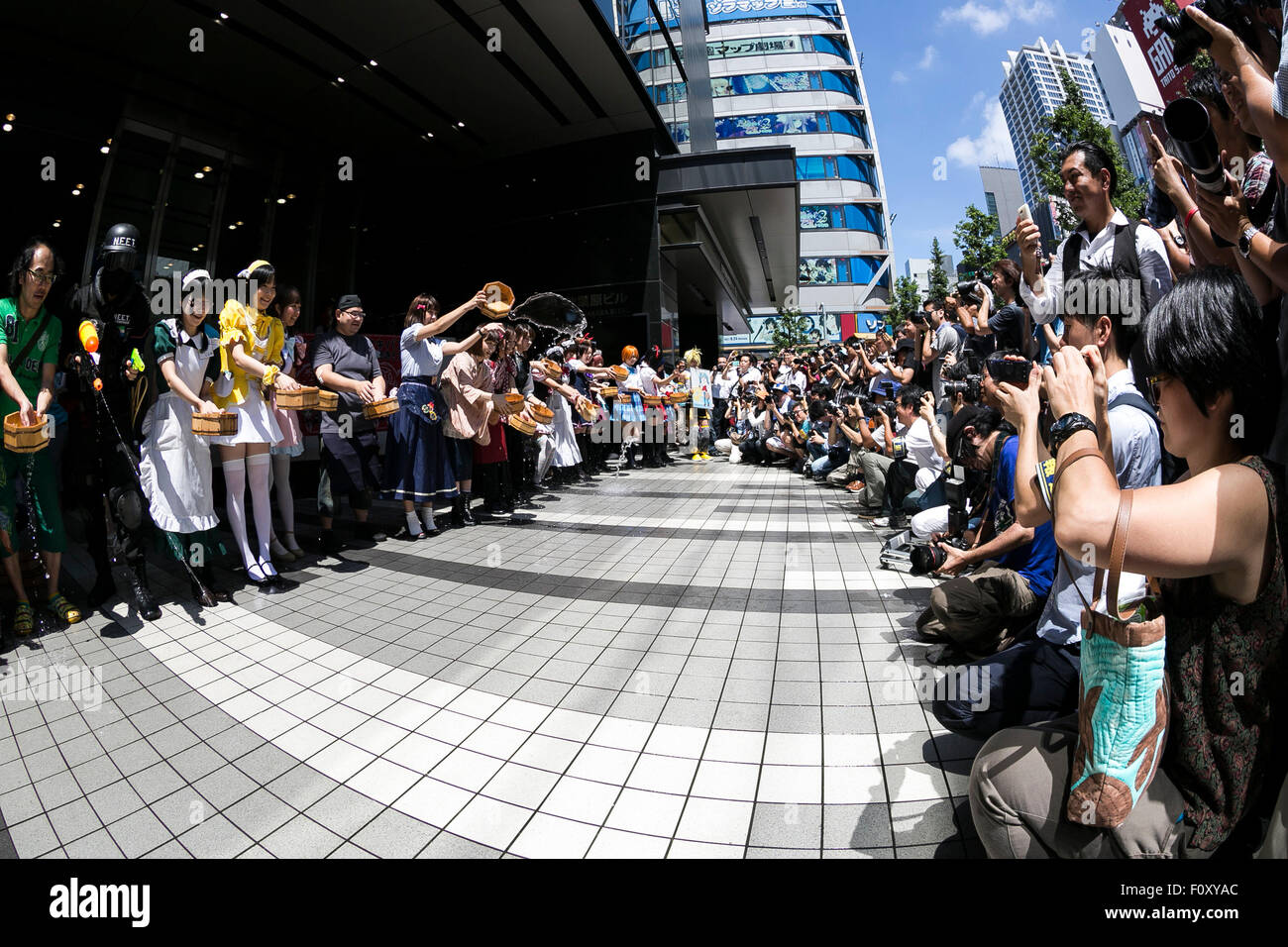 Maid cafe waitresses and cosplayers sprinkle water during the ...