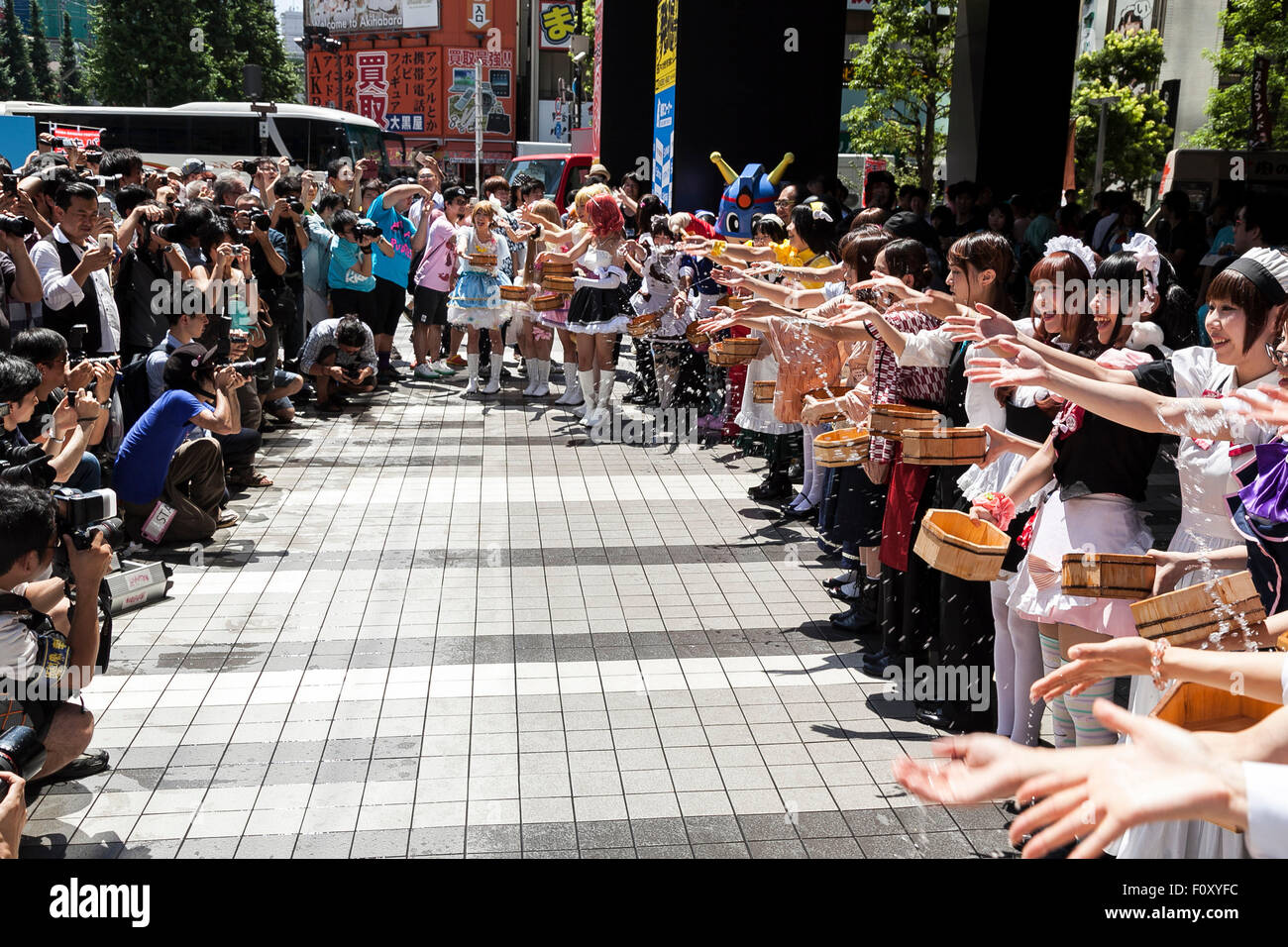 Maid cafe waitresses and cosplayers sprinkle water during the ...