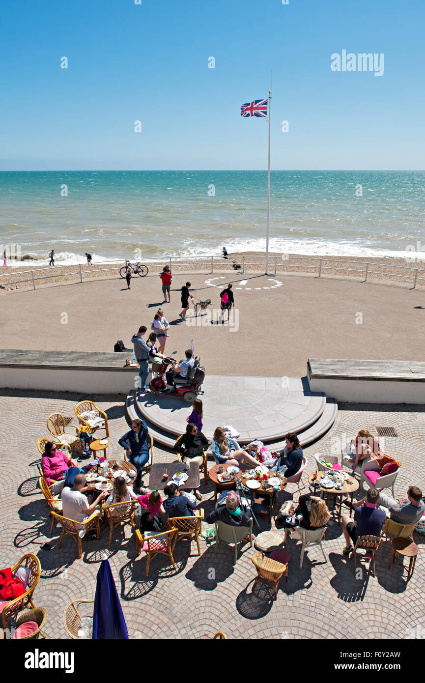 People sitting in the sunshine below the Colonnade on Bexhill seafront ...