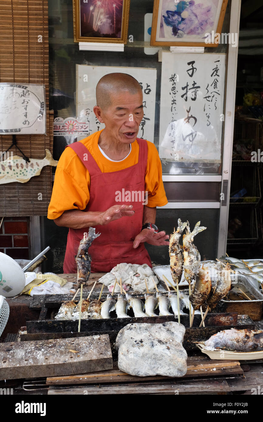 A street stall in Japan selling "ayu", in English known as sweetfish ...