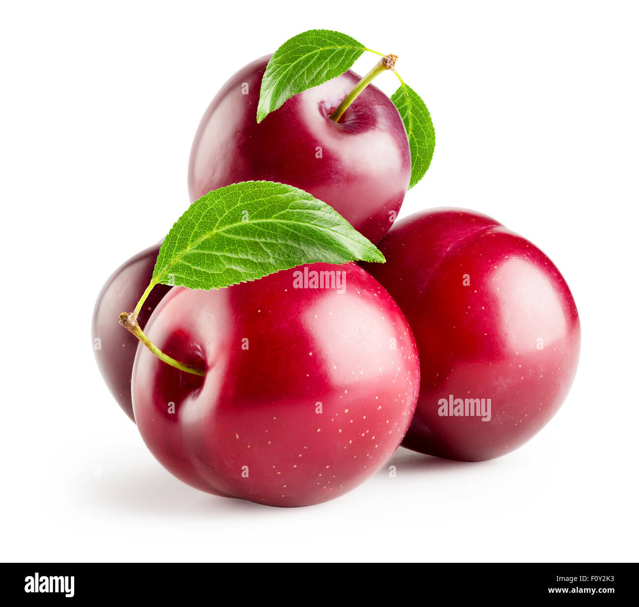 Four plums with leaves isolated on white background Stock Photo - Alamy
