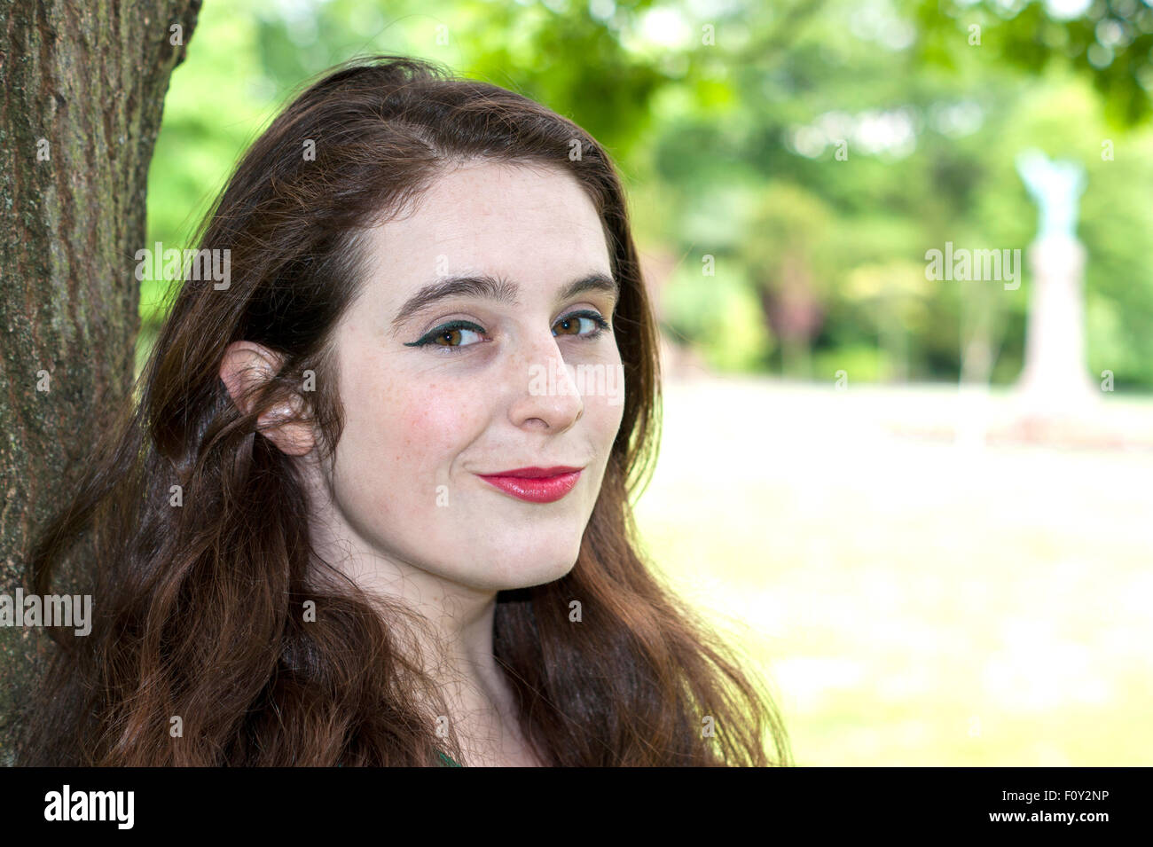 Headshot of a young woman with unique hazel eyes, and curly brown hair ...