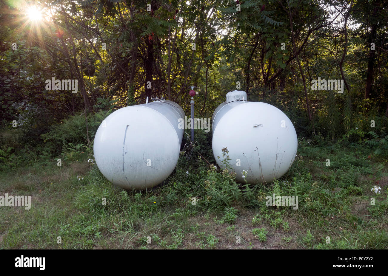 Two grunge propane tanks in the rural area Stock Photo - Alamy
