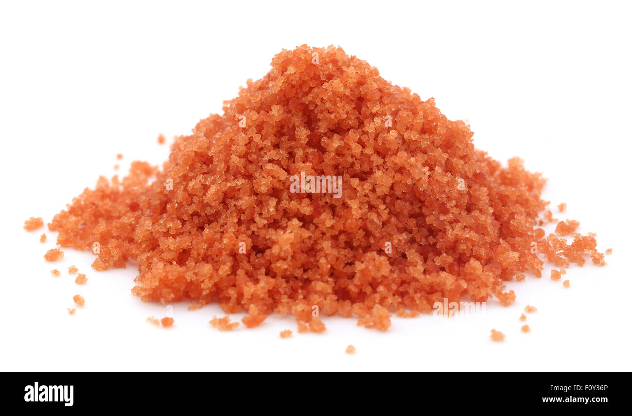 Pile of red sugar over white background Stock Photo - Alamy
