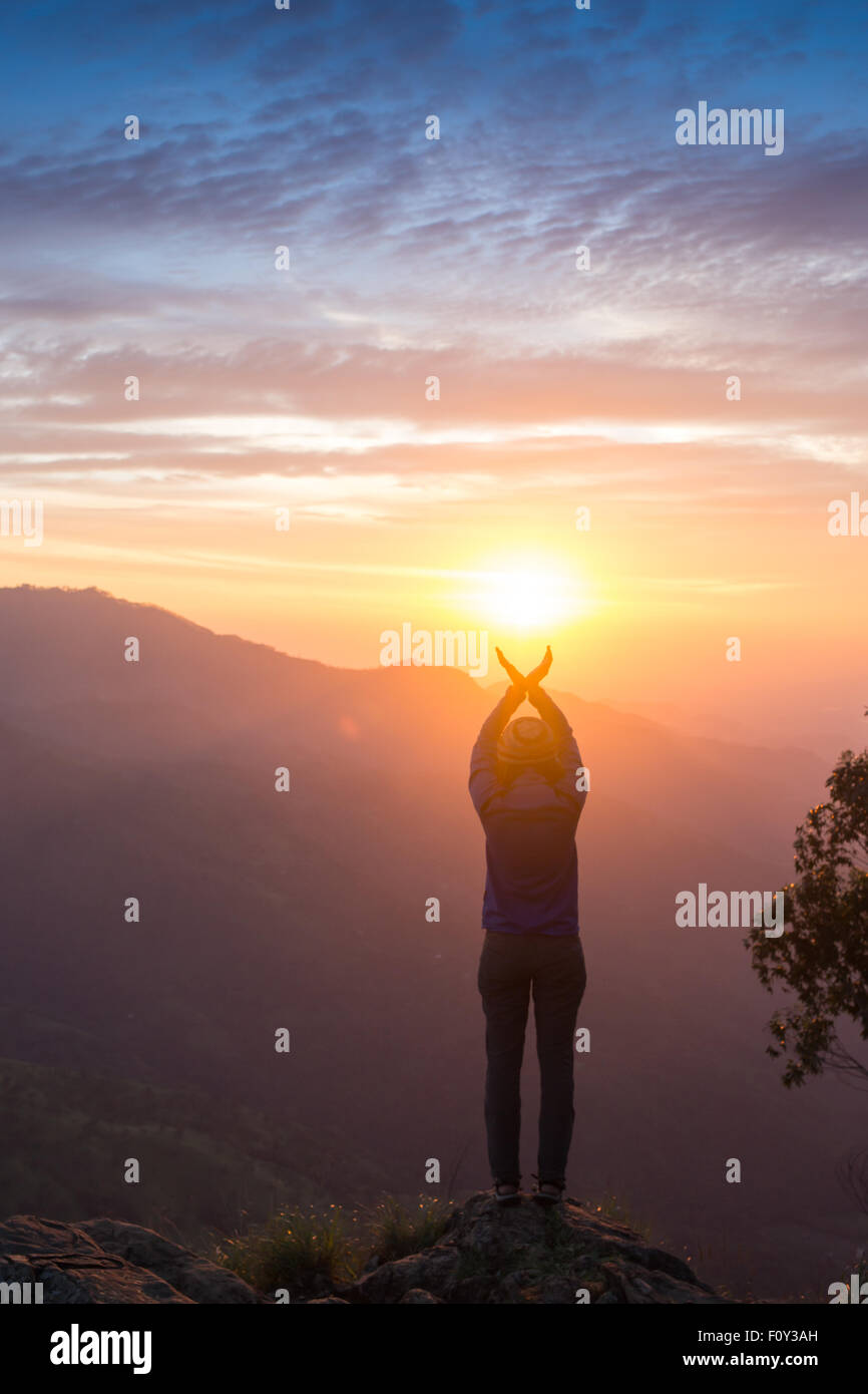 Happy celebrating winning success woman at sunset or sunrise standing ...