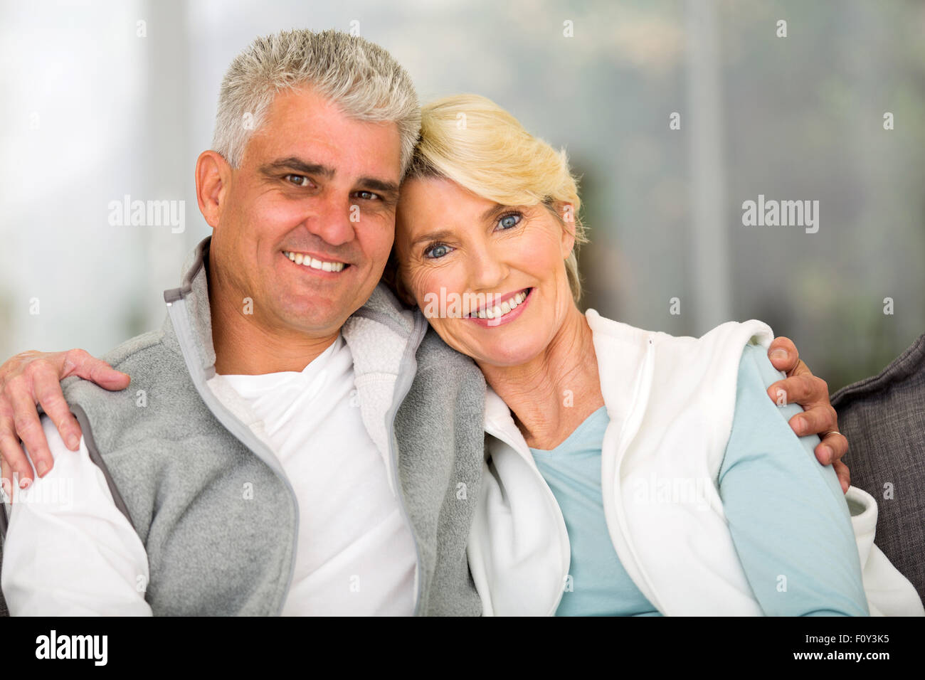 Smiling mature couple relaxing at home hi-res stock photography and ...