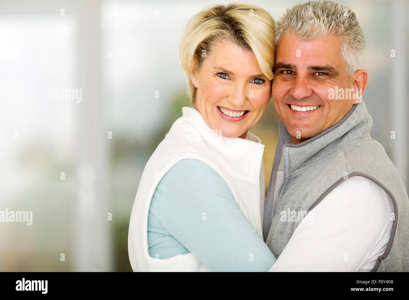 beautiful middle aged couple embracing at home Stock Photo - Alamy