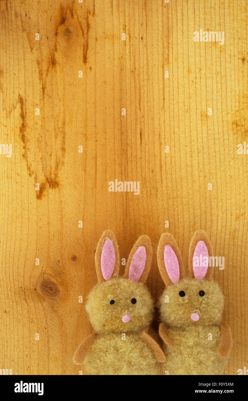 Two fluffy models of beige rabbits with pink ears and surprised ...
