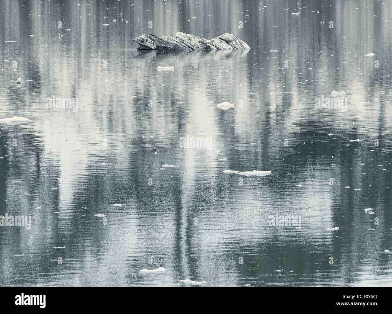Small Ice formation and mountain reflection in water Stock Photo - Alamy