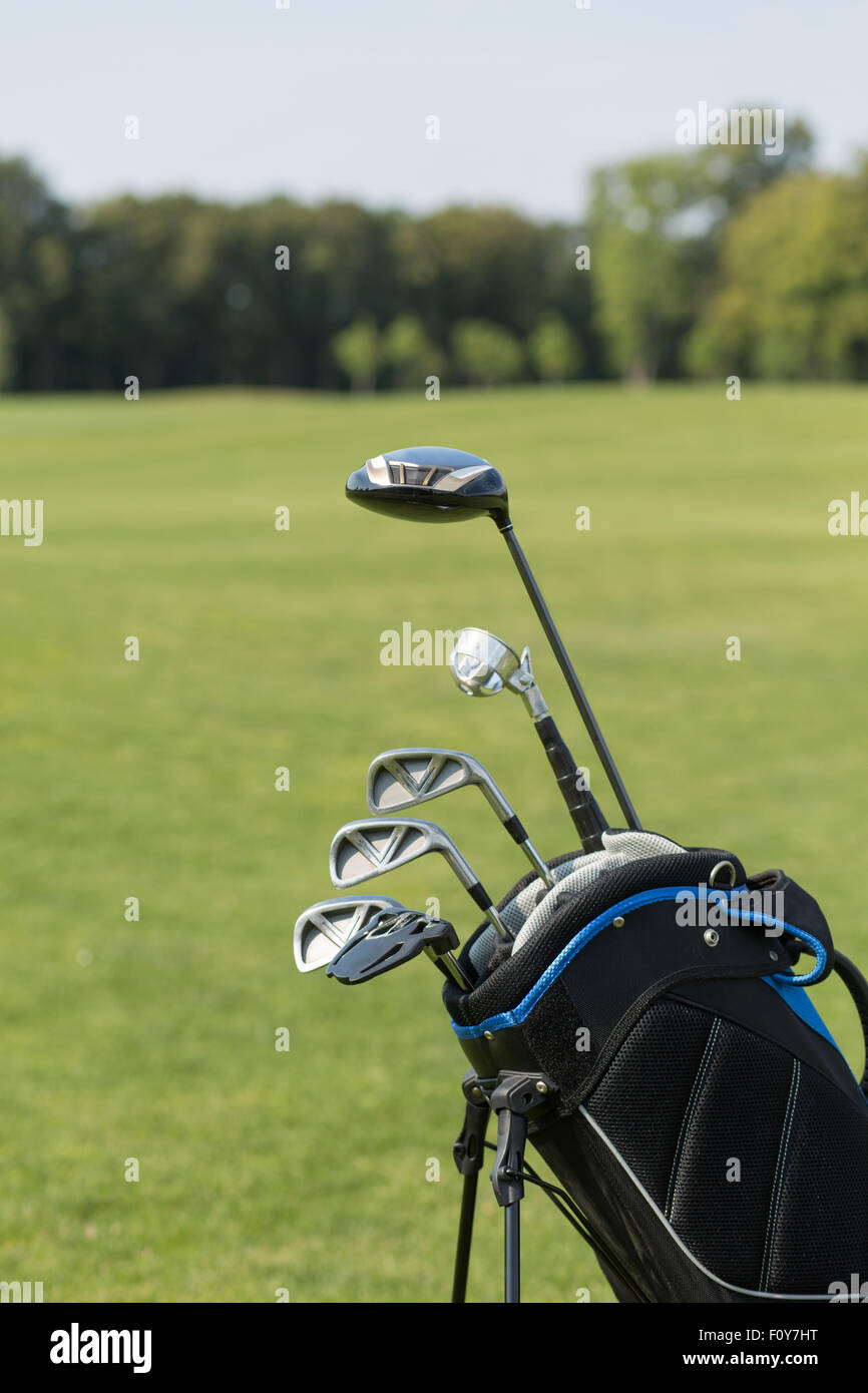 Golf club against the background of green field. Golf organizer cart ...