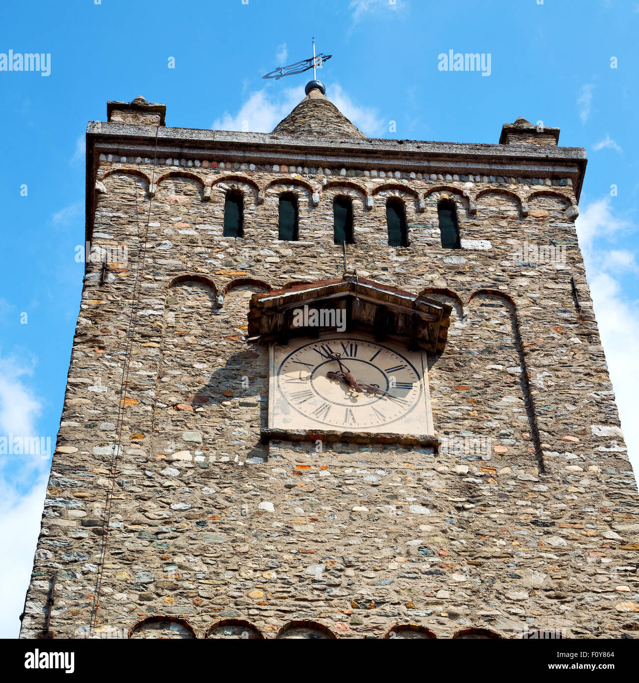 ancien clock tower in italy europe old stone and bell Stock Photo - Alamy