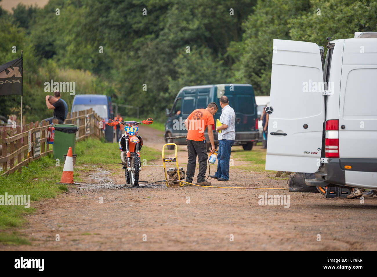 A man jet washing his bike at motocross track J4M54 during a break in ...