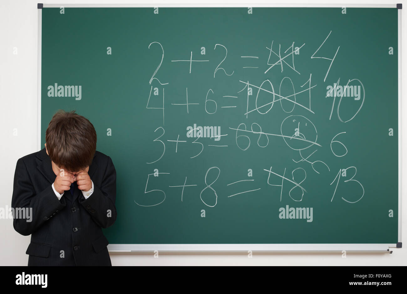 School boy solve math on the school board Stock Photo - Alamy