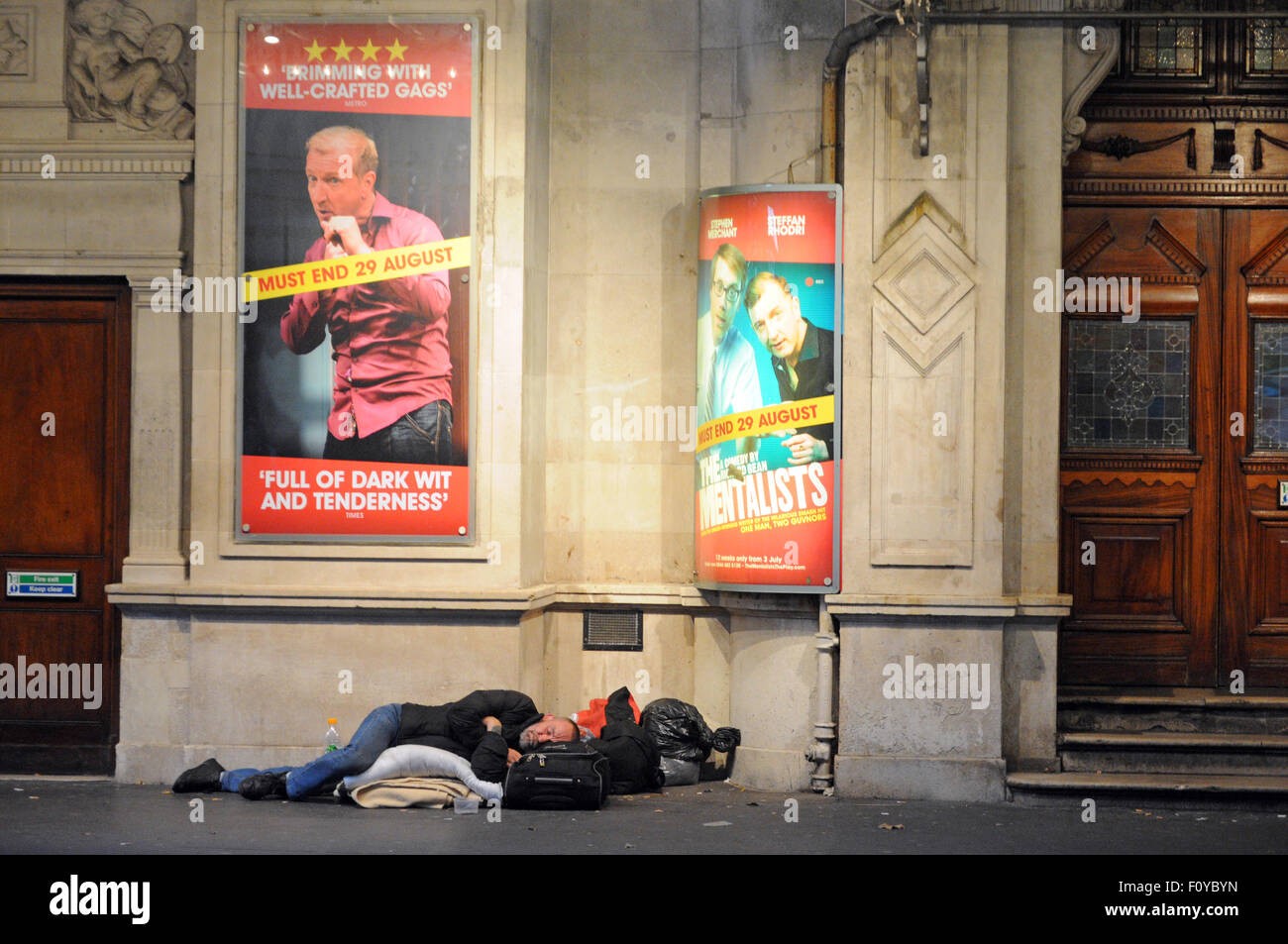 London, UK, 21.08/2015, a homeless man sleeps under the advertising ...
