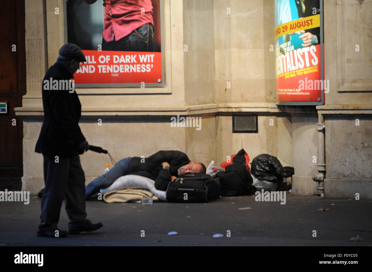London, UK, 21.08/2015, a homeless man sleeps under the advertising ...