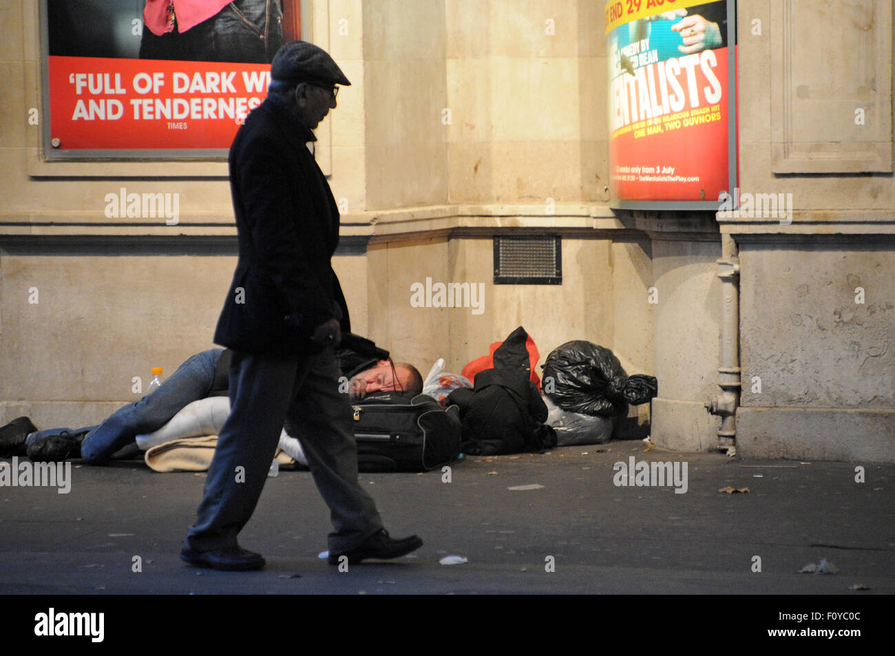 London, UK, 21.08/2015, a homeless man sleeps under the advertising ...
