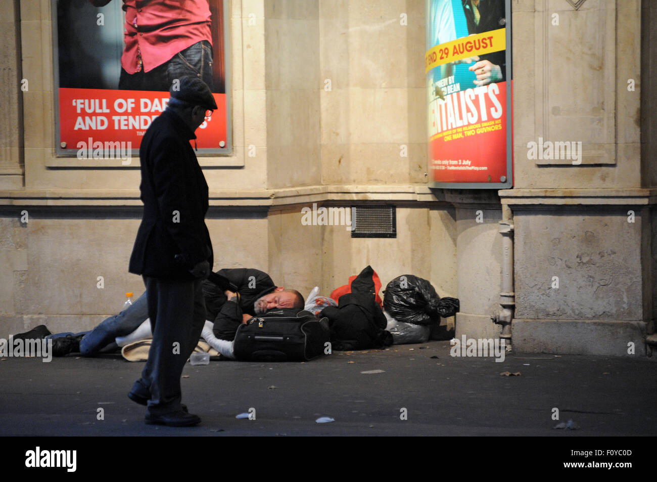 London, UK, 21.08/2015, a homeless man sleeps under the advertising ...