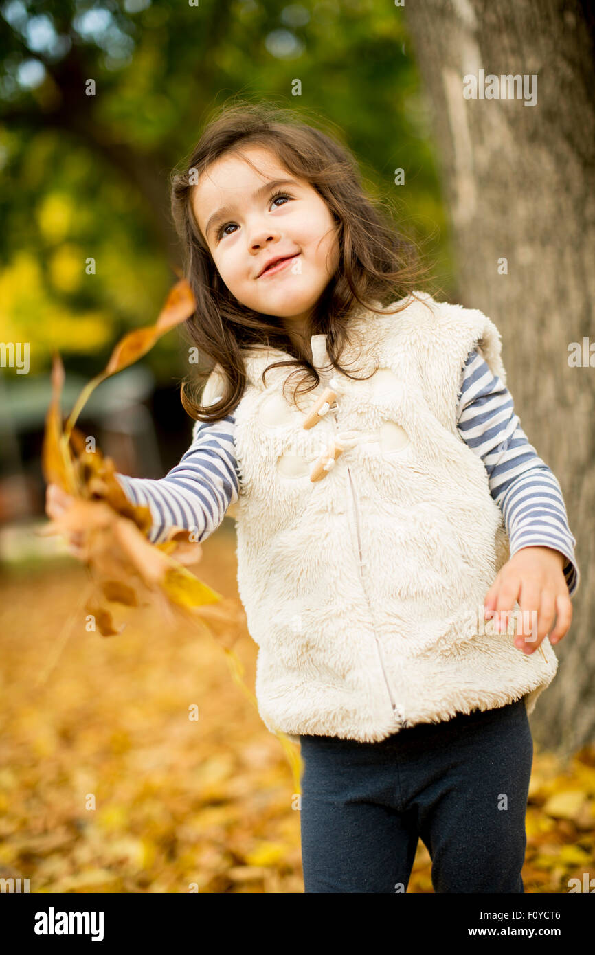 Little girl at the autumn park Stock Photo - Alamy