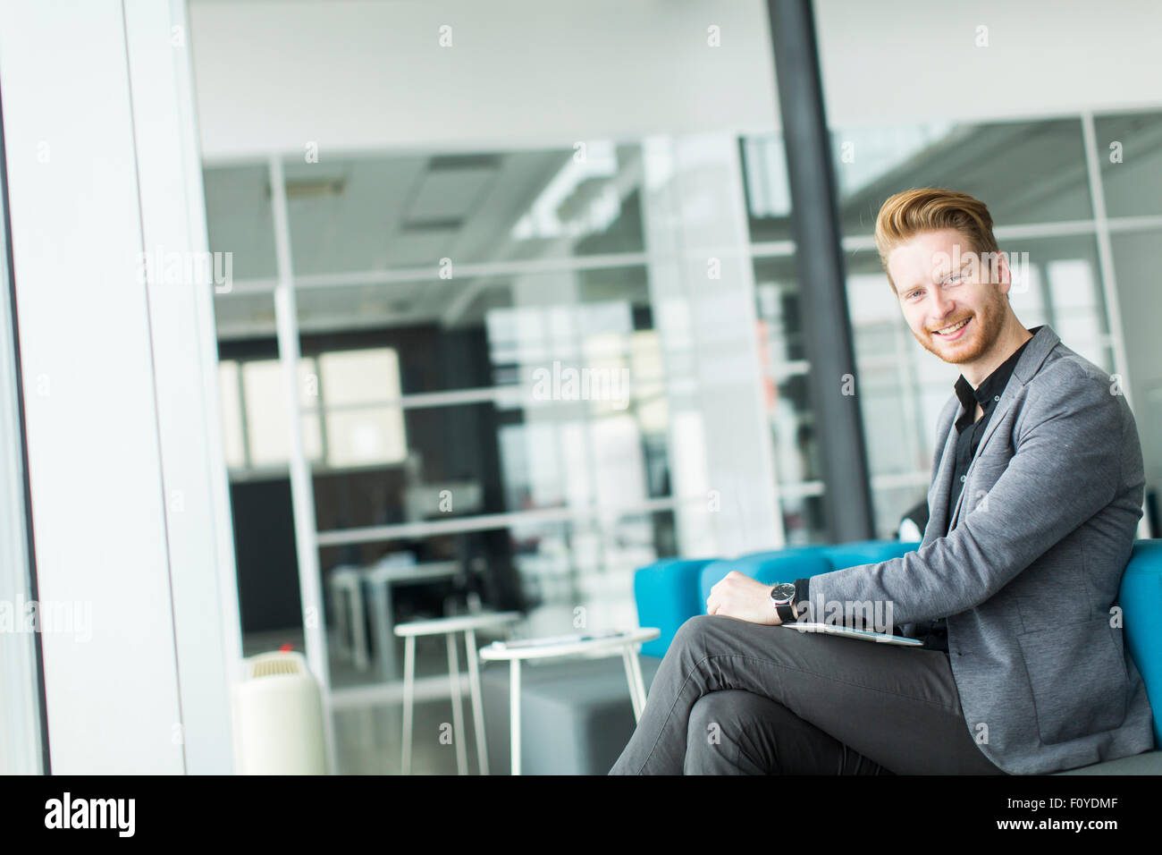 Young man in the office Stock Photo - Alamy