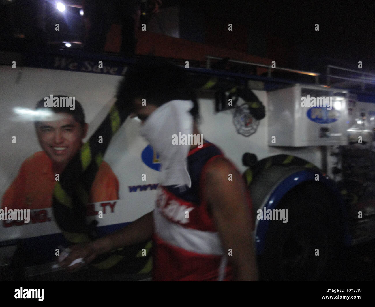 Quezon City, Philippines. 23rd Aug, 2015. A Filipino man covers his ...