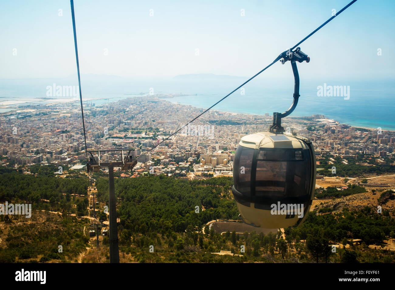 Landscape of Trapani city from the cableway of Erice. Cable cars climb ...