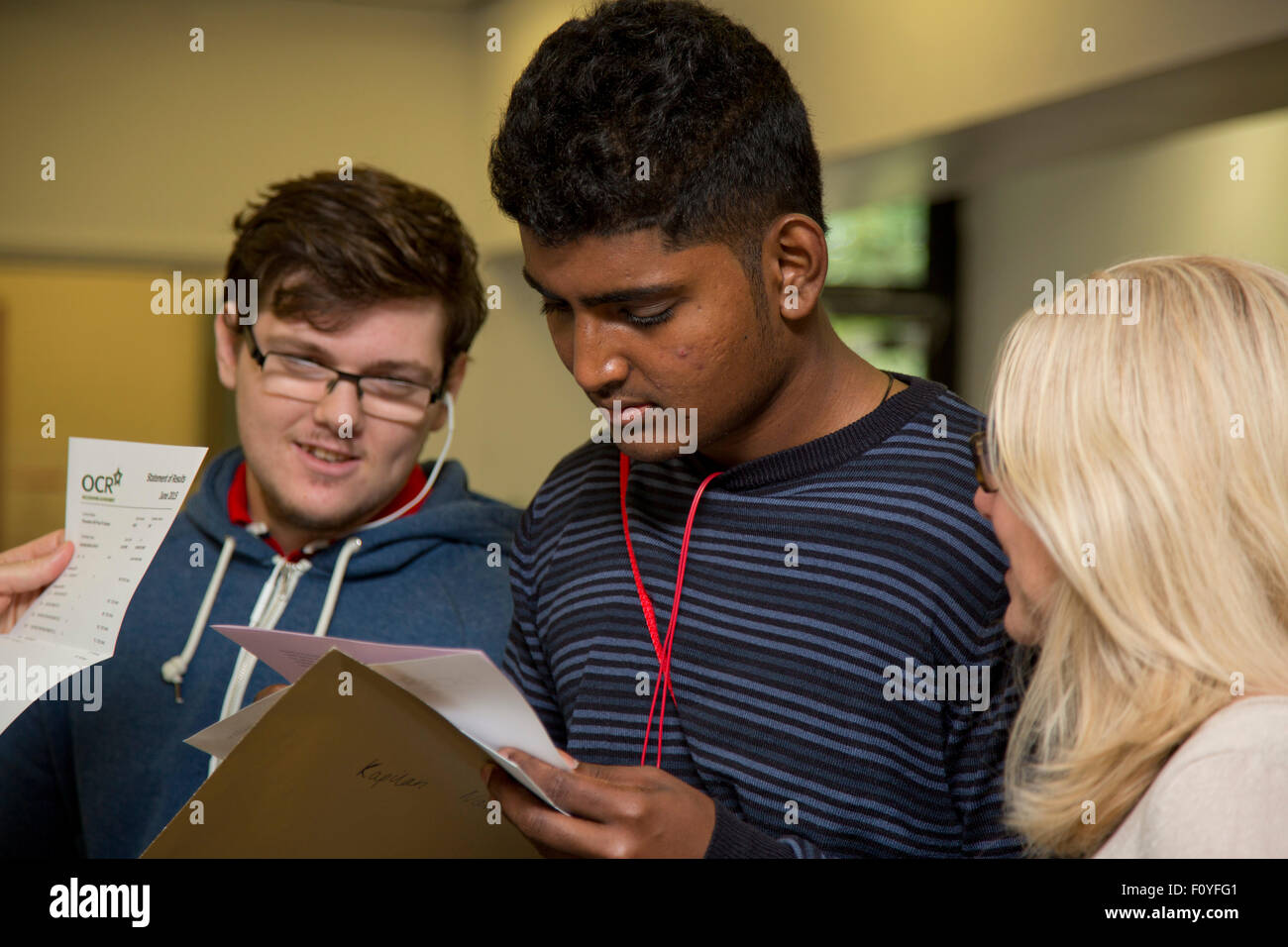 Students getting their results from teacher Stock Photo - Alamy