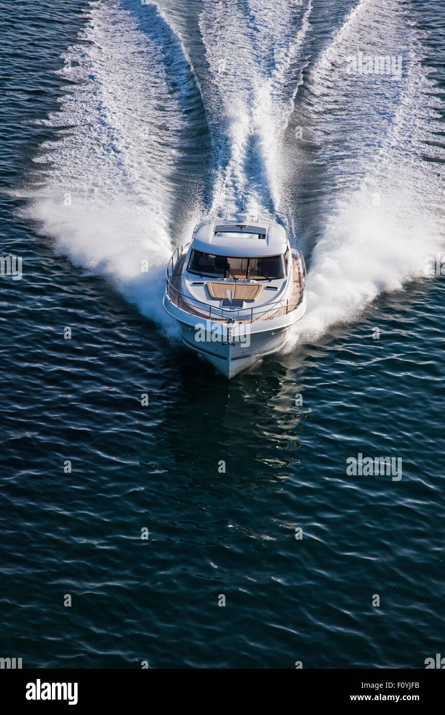 Front picture of a white speed boat sailing on a bright and sunny day ...