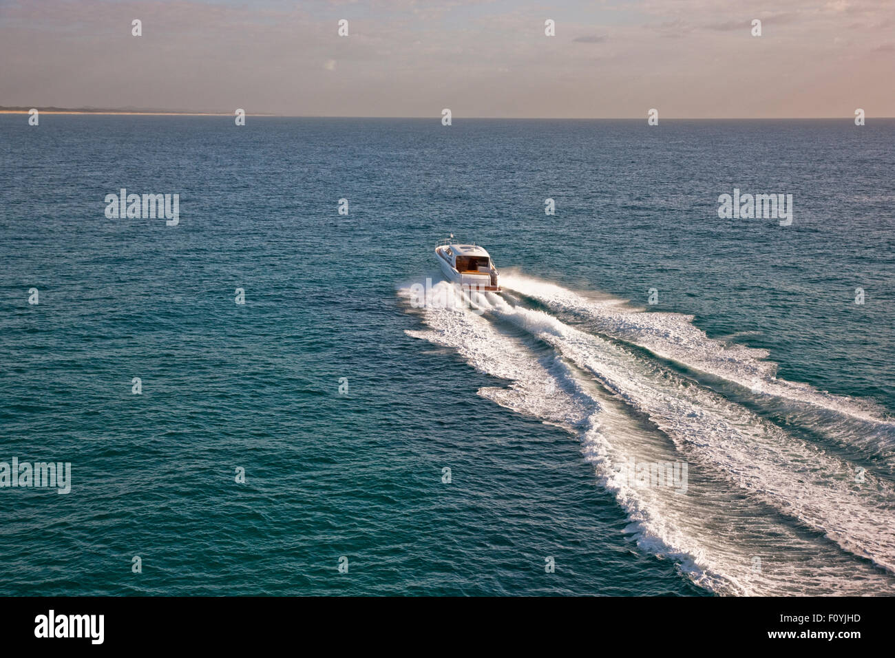 Small speed boat sailing through a call sea in the evening Stock Photo ...