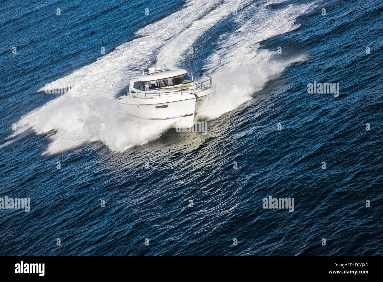 Image of a speed boat making a turn while sailing in a beautiful sea ...