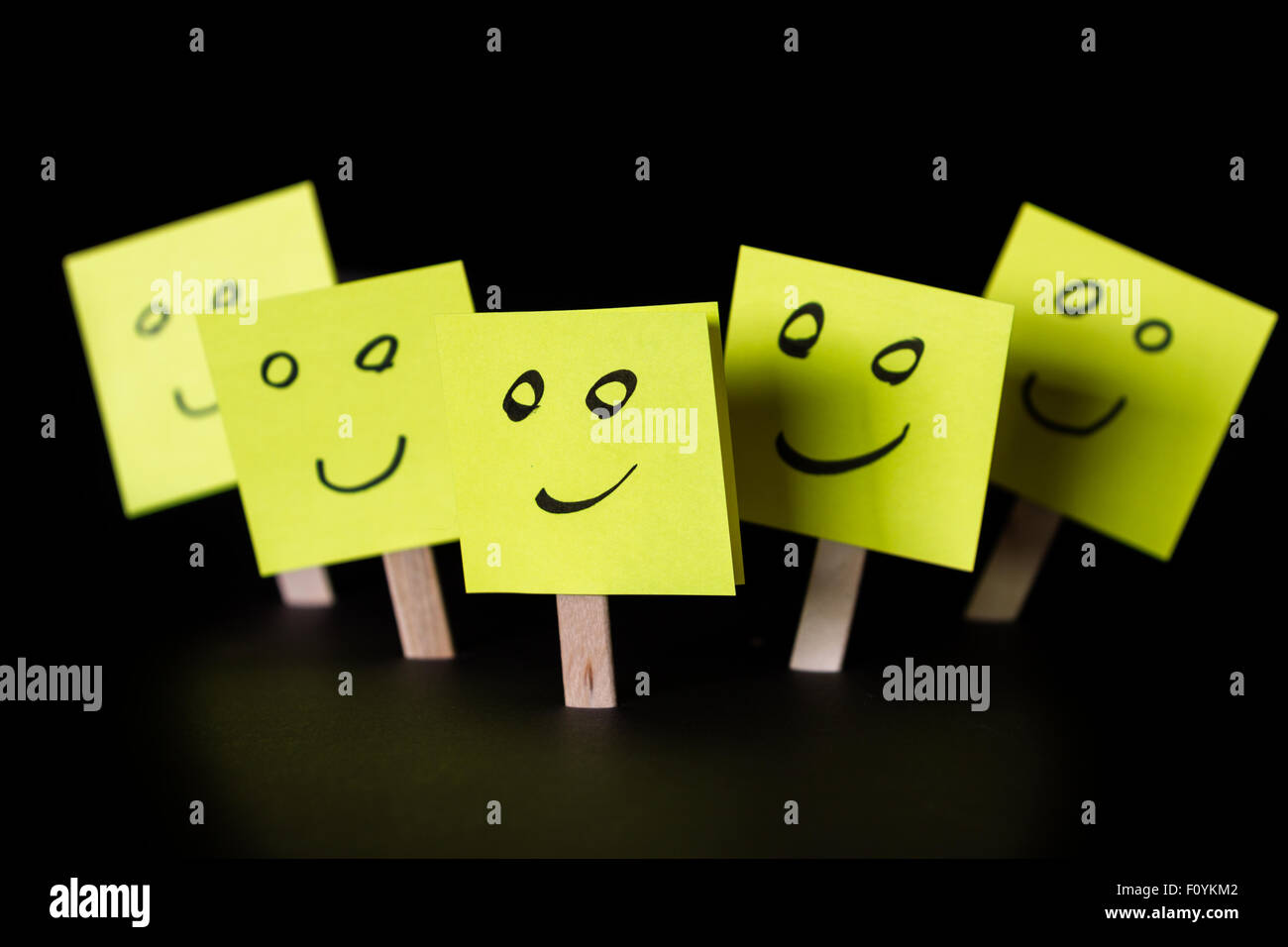 sticky notes with happy faces isolated on a black background for a ...