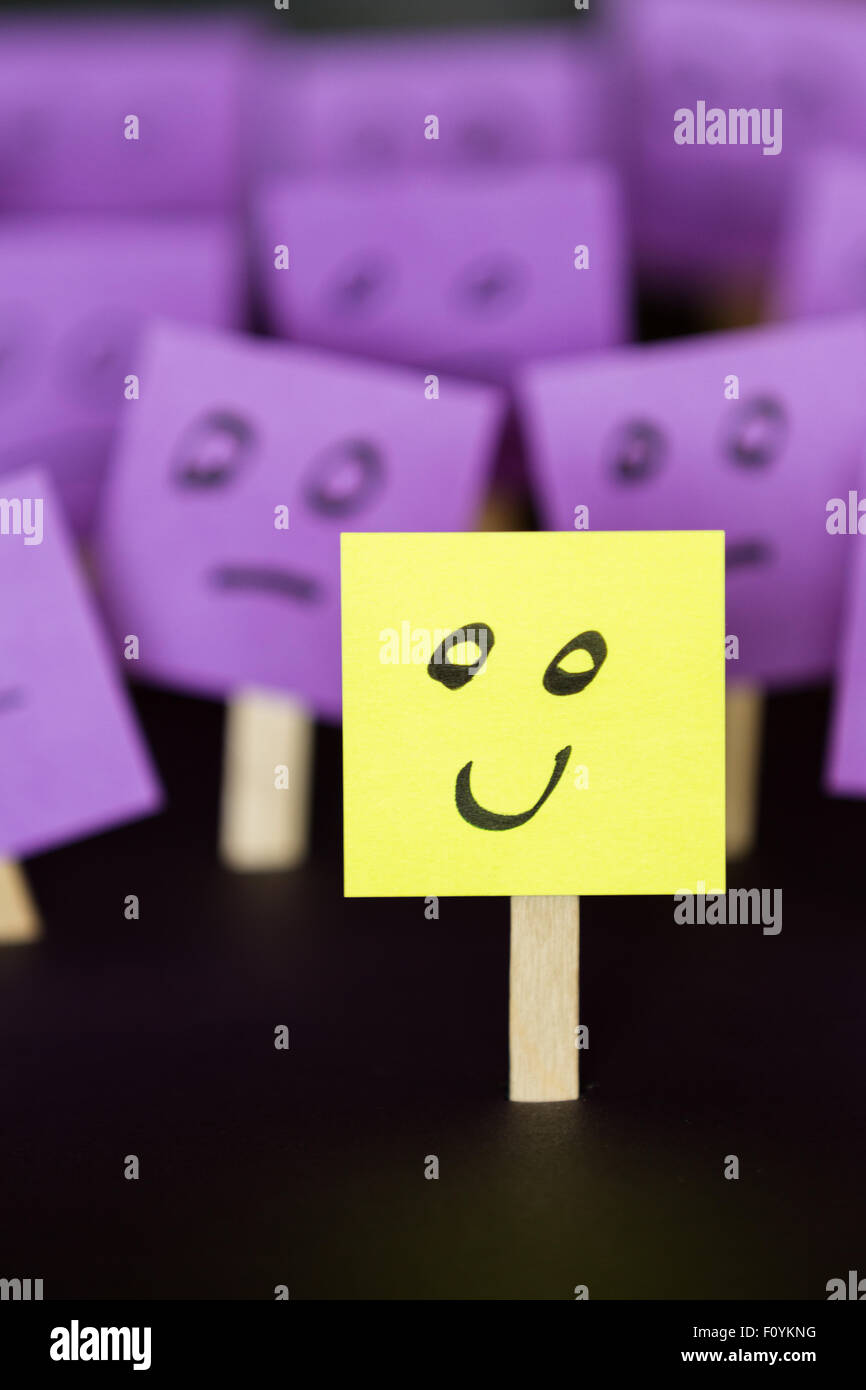 hand drawn faces on sticky notes with on that stands out in a positive ...