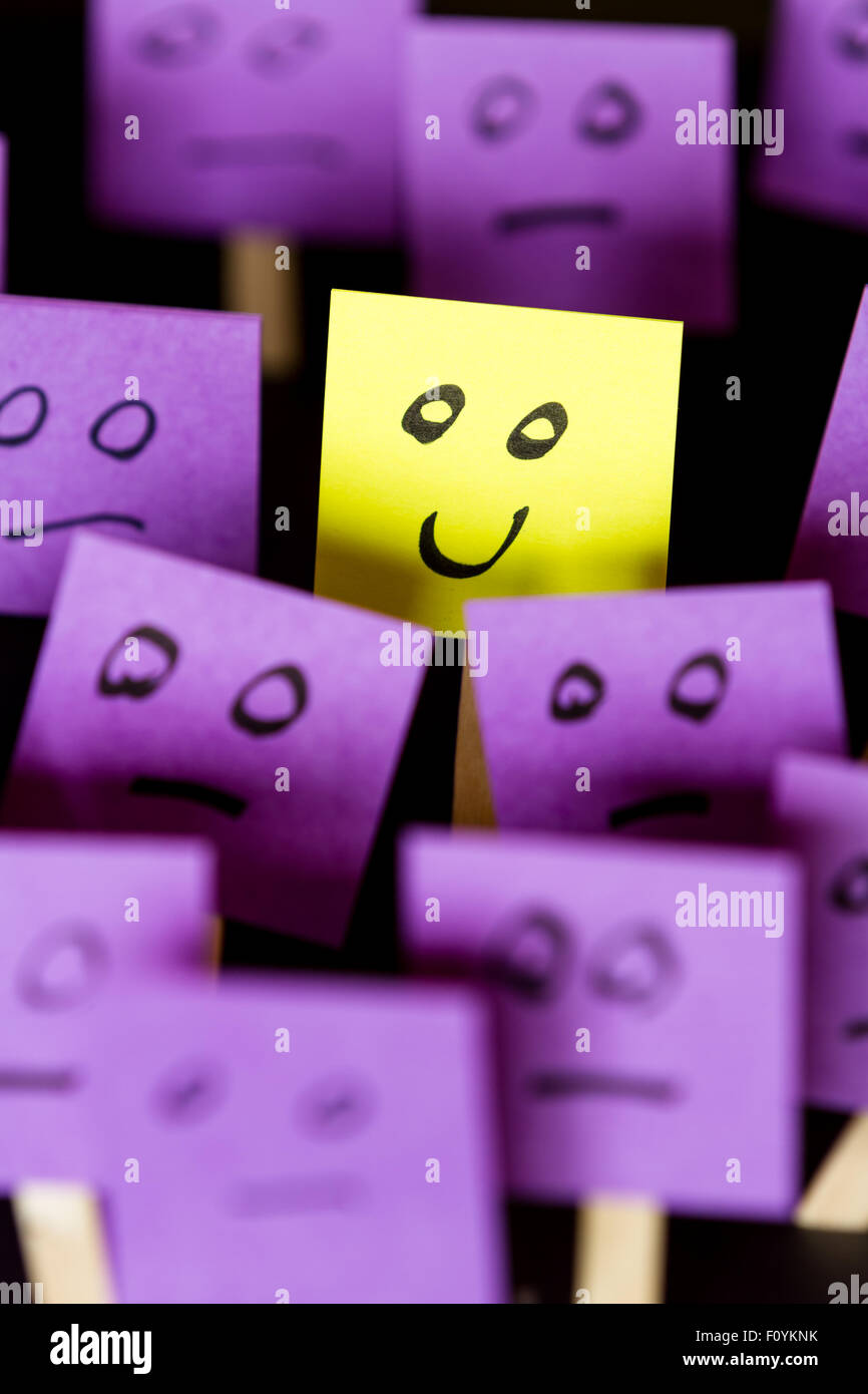hand drawn faces on sticky notes with on that stands out in a positive ...
