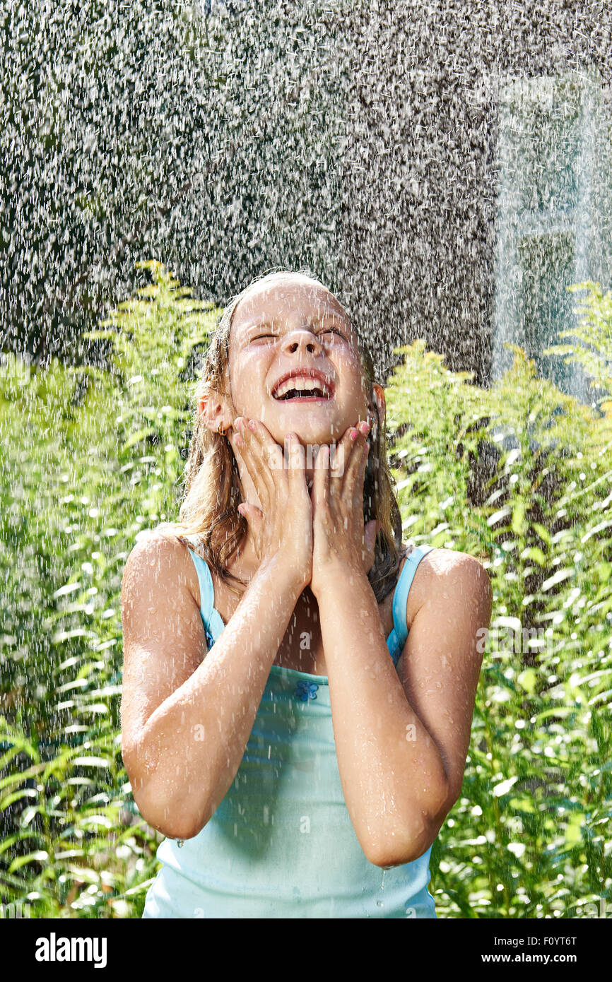 Happy girl under summer rain Stock Photo - Alamy
