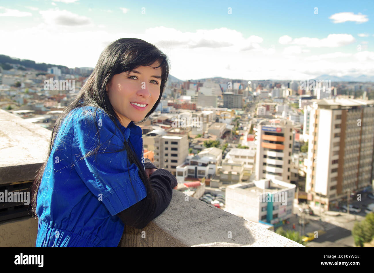 Beautiful young girl sitting on the roof Stock Photo - Alamy