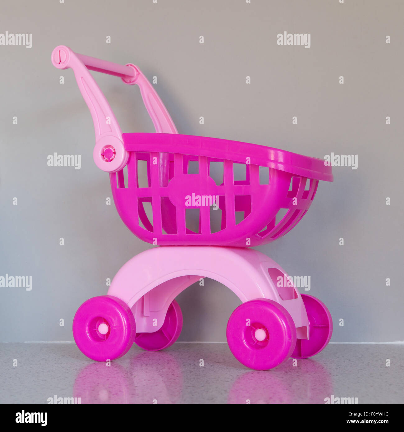 Pink shopping cart in a living room Stock Photo - Alamy