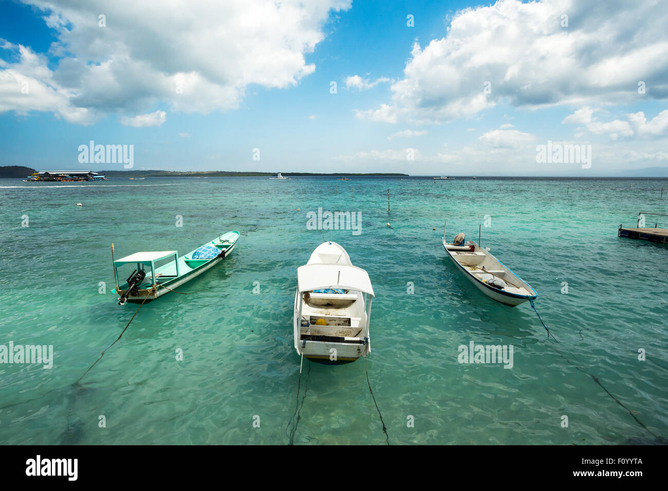 romantic Small boats on nusa penida beach, Bali Indonesia with blue sky ...