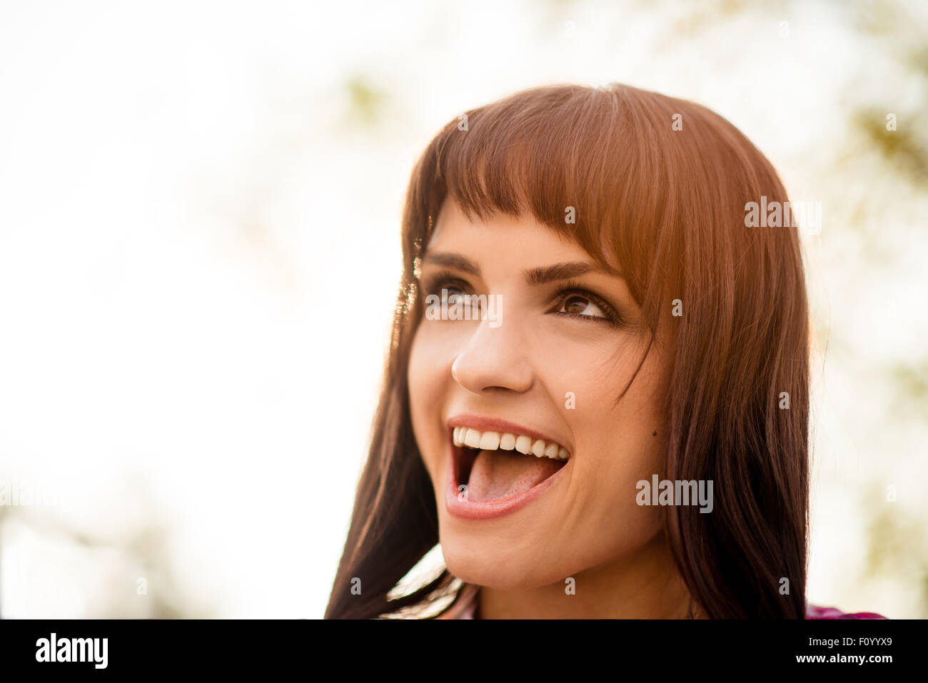 Outdoor portrait of beautiful young woman screaming out Stock Photo - Alamy