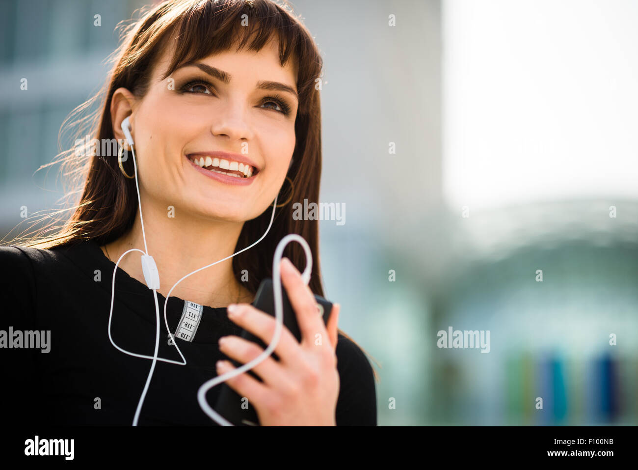 Young woman calling phone with hands free in street Stock Photo - Alamy