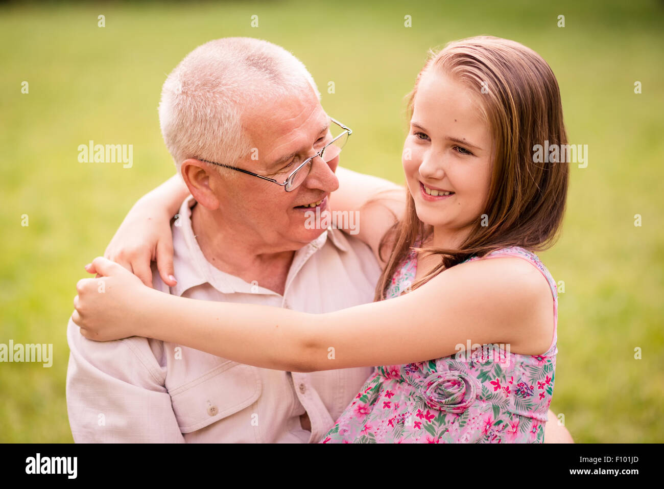 Smiling child hugging her happy grandfather - outdor in nature Stock ...