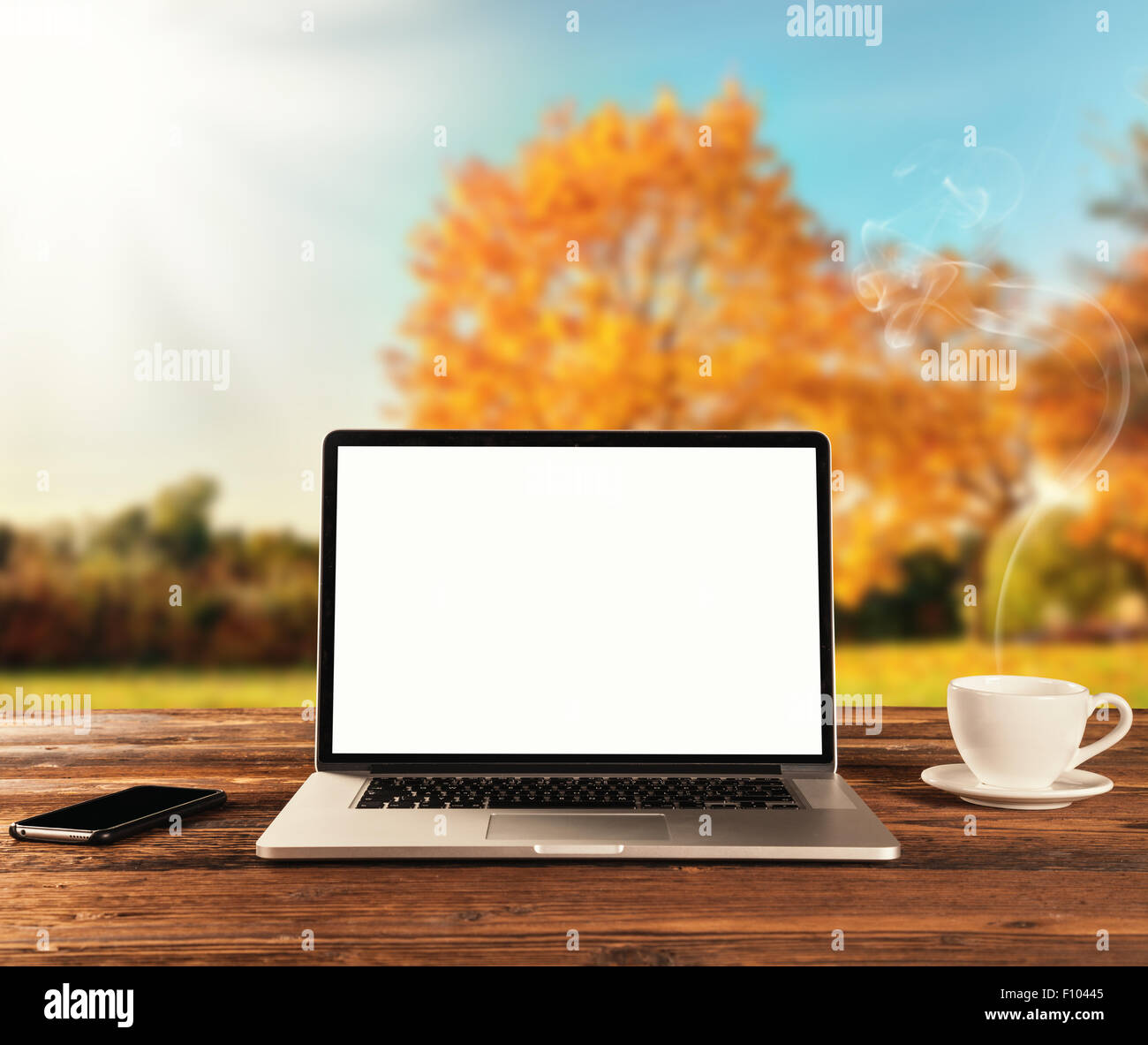 Laptop on wooden table in autumn season Stock Photo - Alamy
