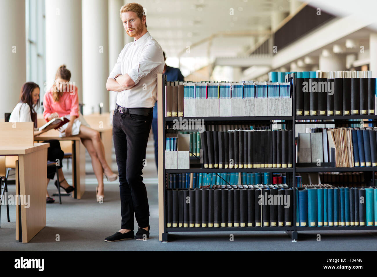 Handsome smart student promoting library and studies Stock Photo - Alamy