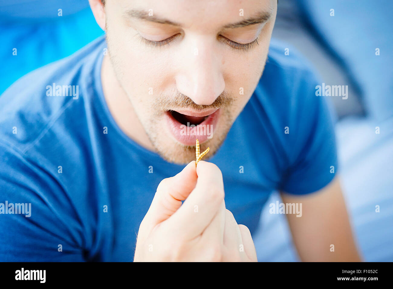 MAN EATING INSECT Stock Photo - Alamy