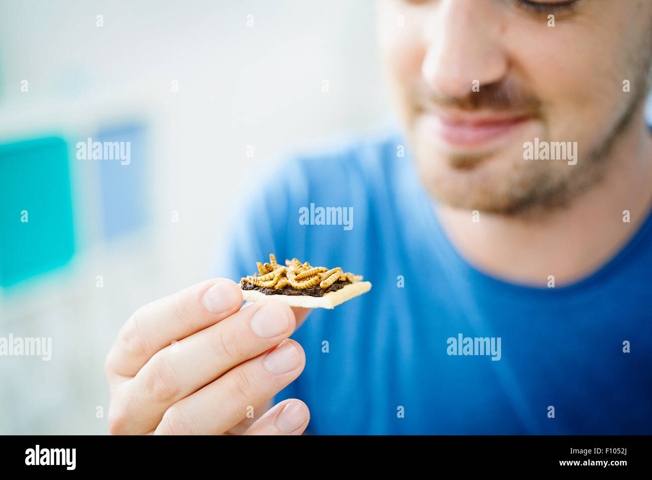 MAN EATING INSECT Stock Photo - Alamy