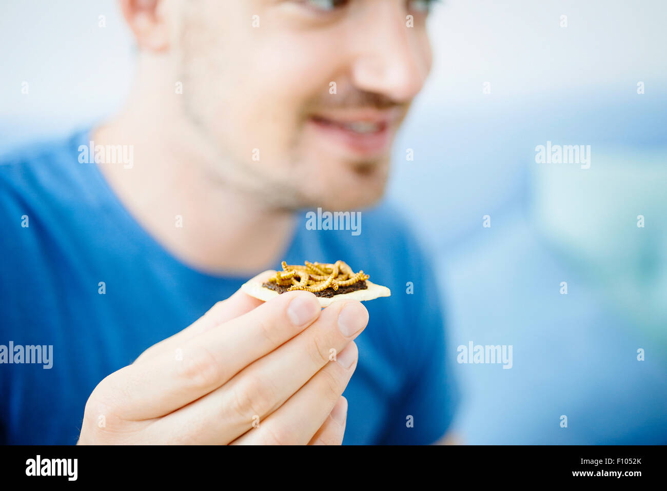 MAN EATING INSECT Stock Photo - Alamy