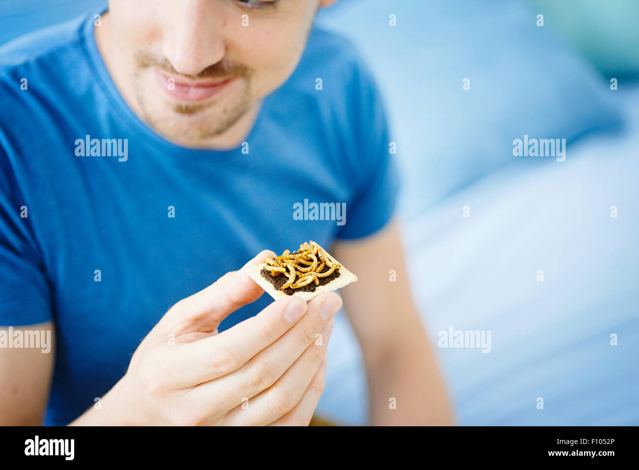 MAN EATING INSECT Stock Photo - Alamy